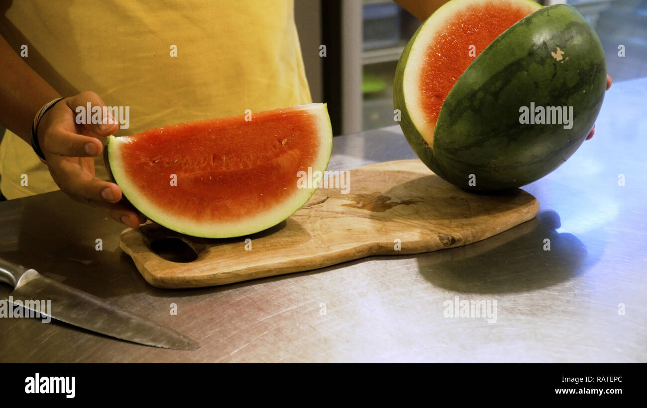 Fresh watermelon slice knife hand hi-res stock photography and images ...