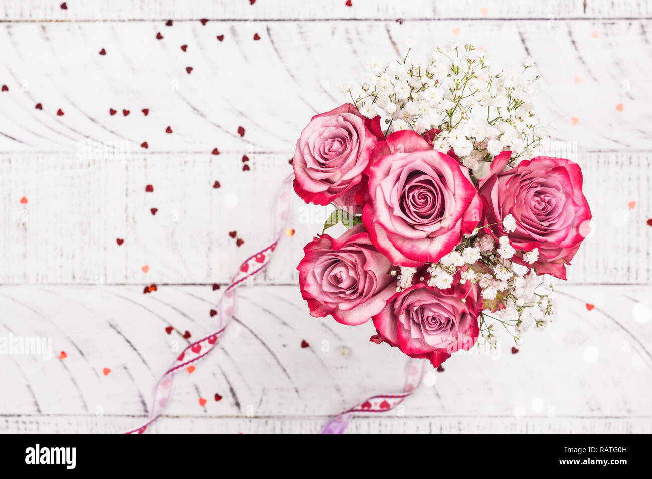 Pink roses in a white pitcher Stock Photo - Alamy