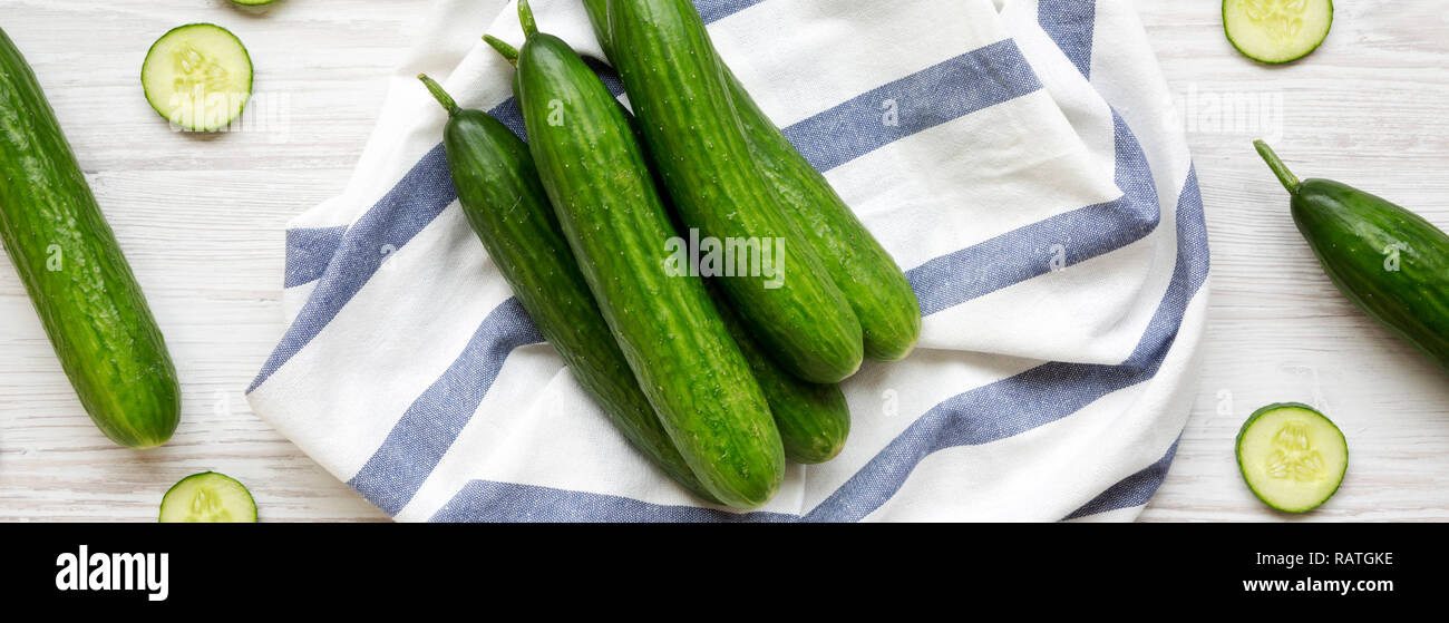 Organic green cucumbers, overhead view. Flat lay, from above, top view ...