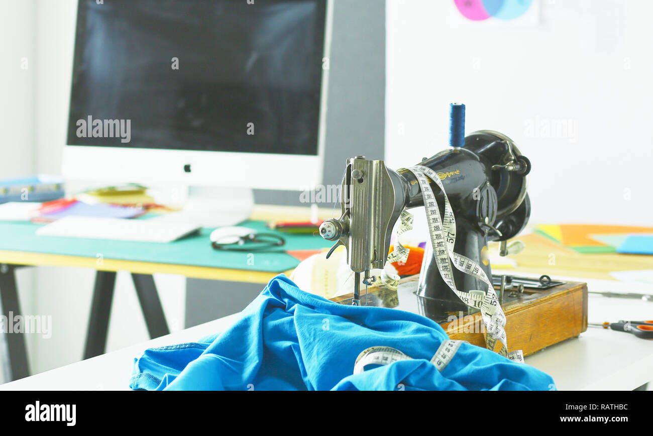 Retro sewing machine on designer clothes desktop Stock Photo - Alamy