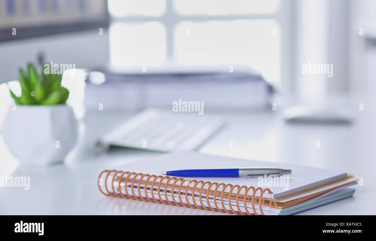 Office table with blank notepad and laptop Stock Photo - Alamy