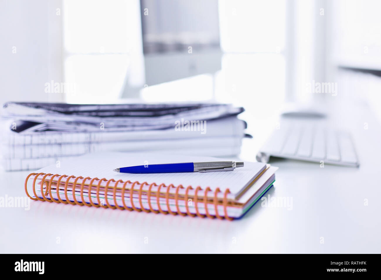 Office table with blank notepad and laptop Stock Photo - Alamy
