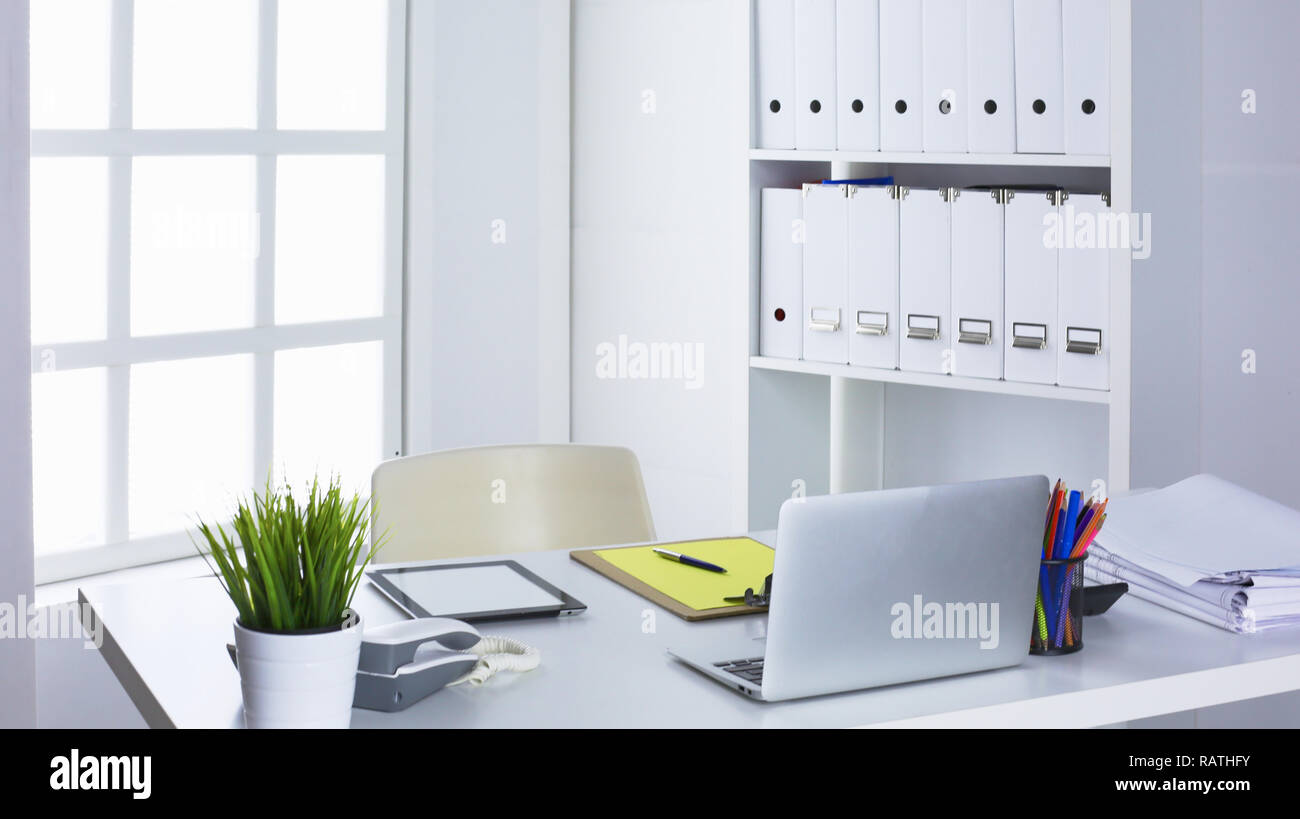 Office table with blank notepad and laptop Stock Photo - Alamy