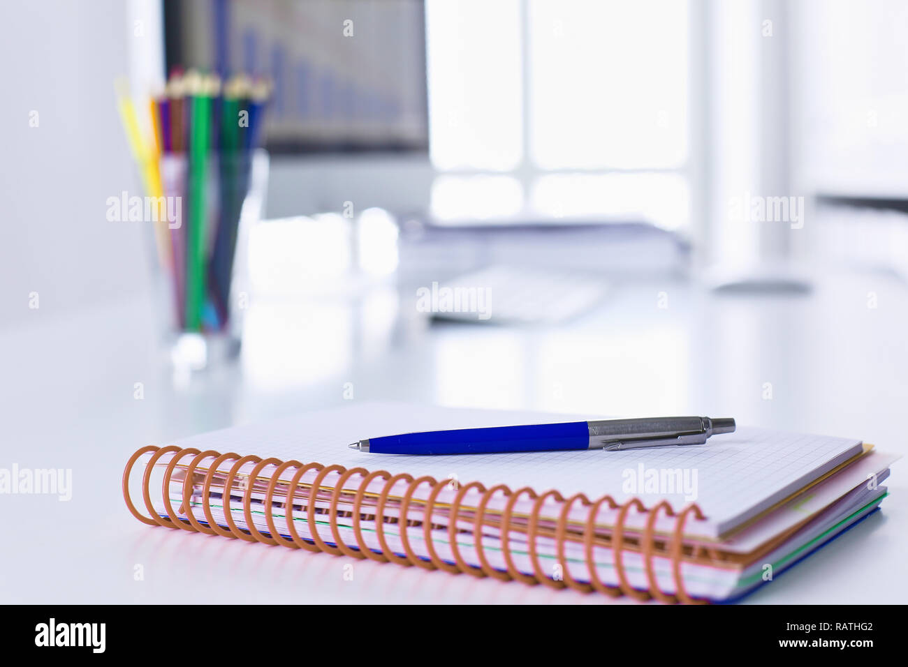 Office table with blank notepad and laptop Stock Photo - Alamy