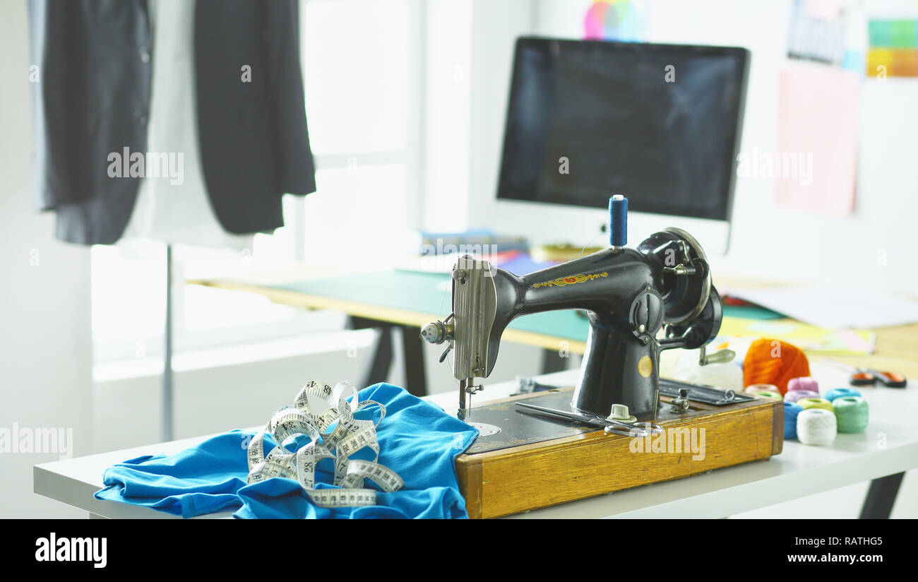 Retro sewing machine on designer clothes desktop Stock Photo - Alamy