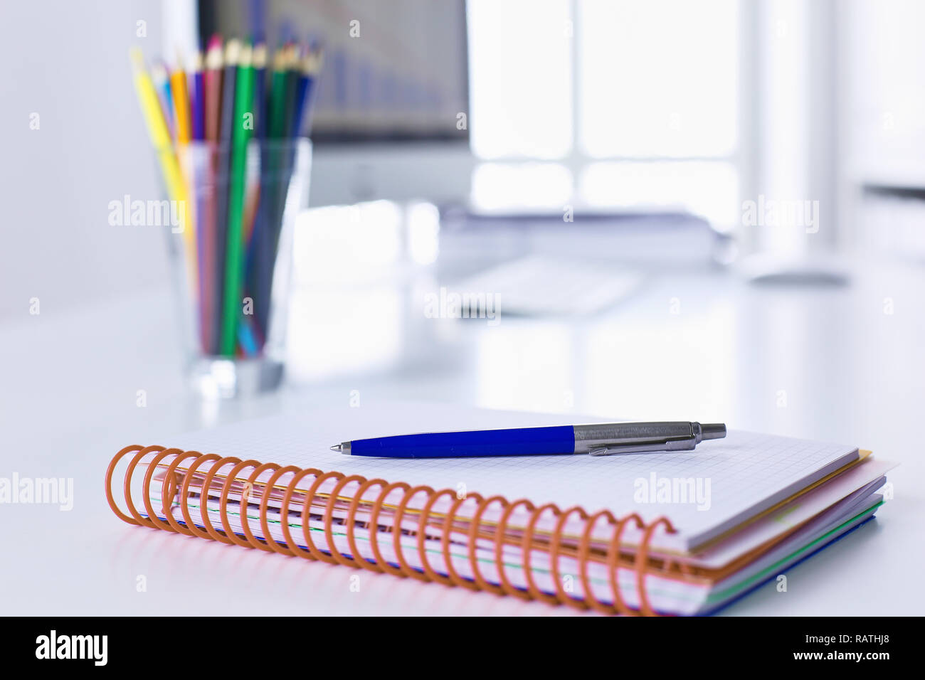 Office table with blank notepad and laptop Stock Photo - Alamy