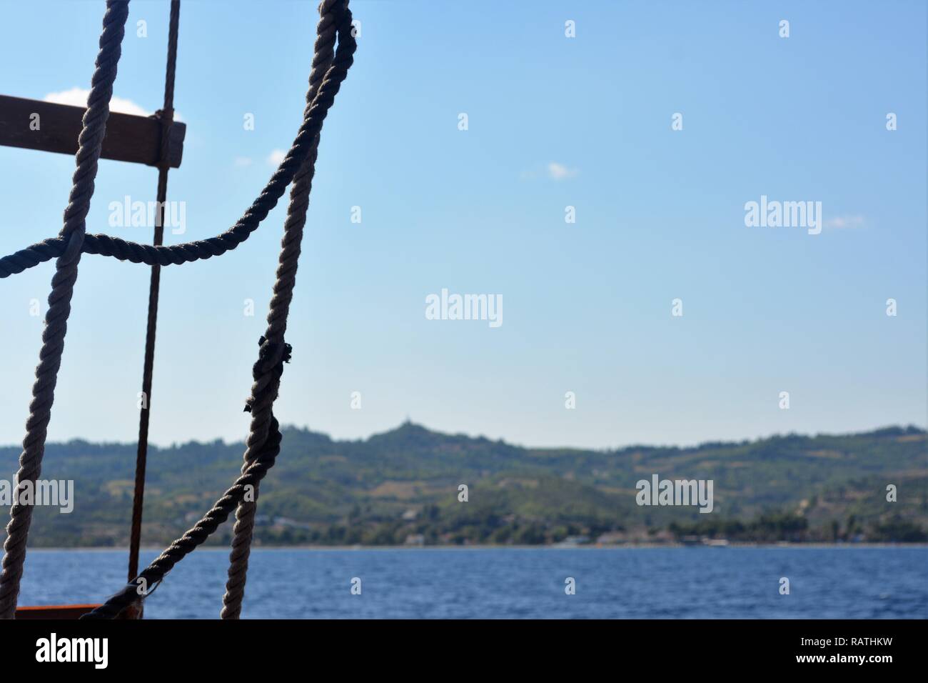 Sailing ship ropes with shore in the background Stock Photo - Alamy
