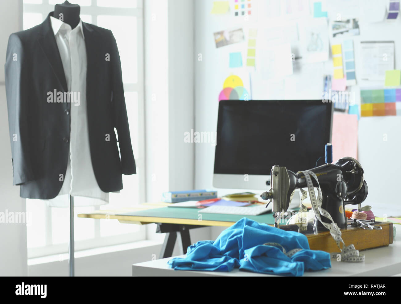 Retro sewing machine on designer clothes desktop Stock Photo - Alamy