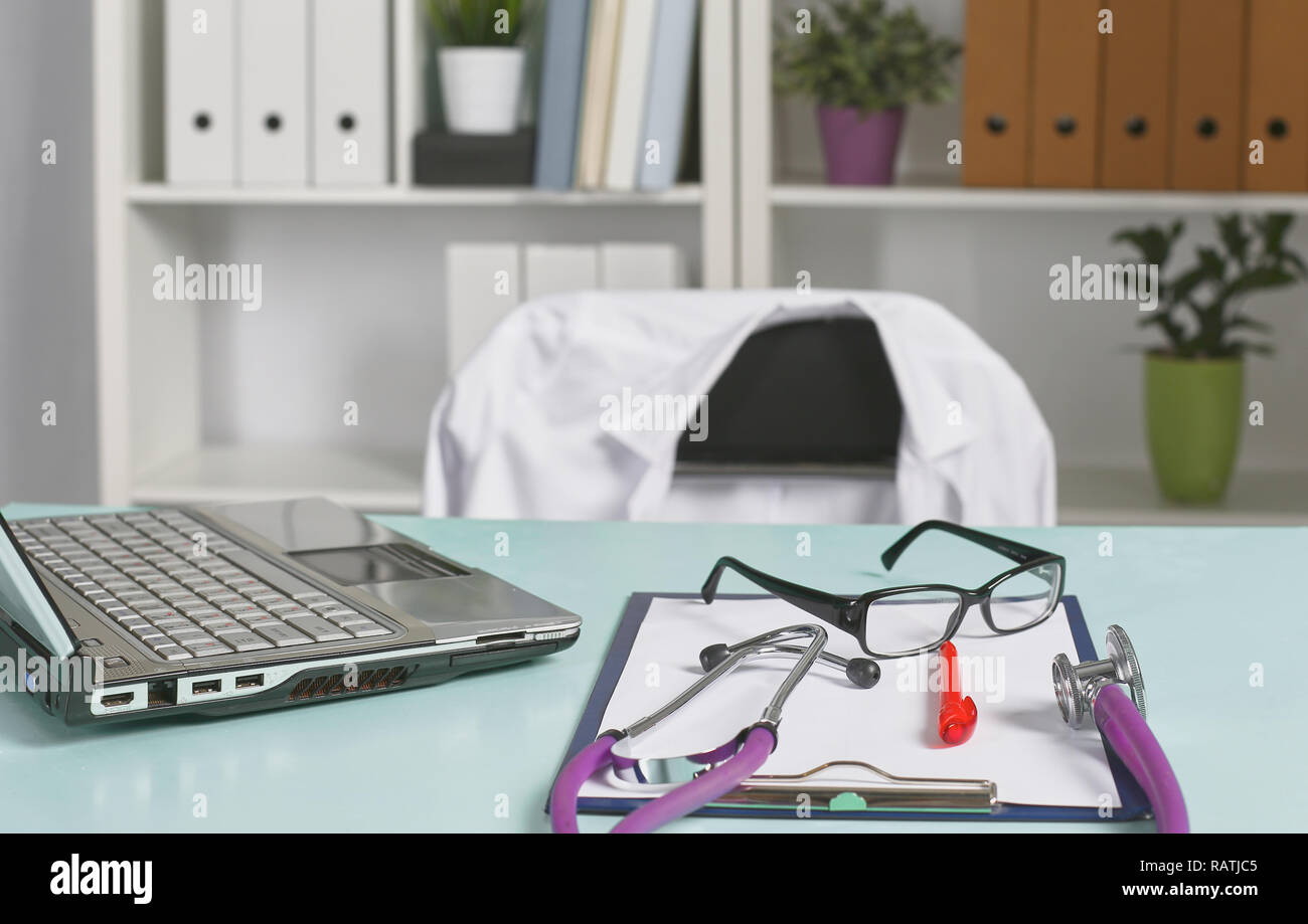 Doctor's workspace working table with patient's discharge blank paper ...