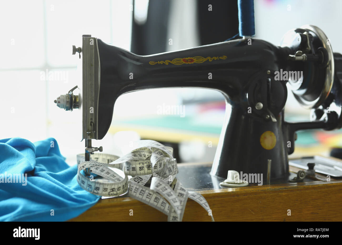 Retro sewing machine on designer clothes desktop Stock Photo - Alamy