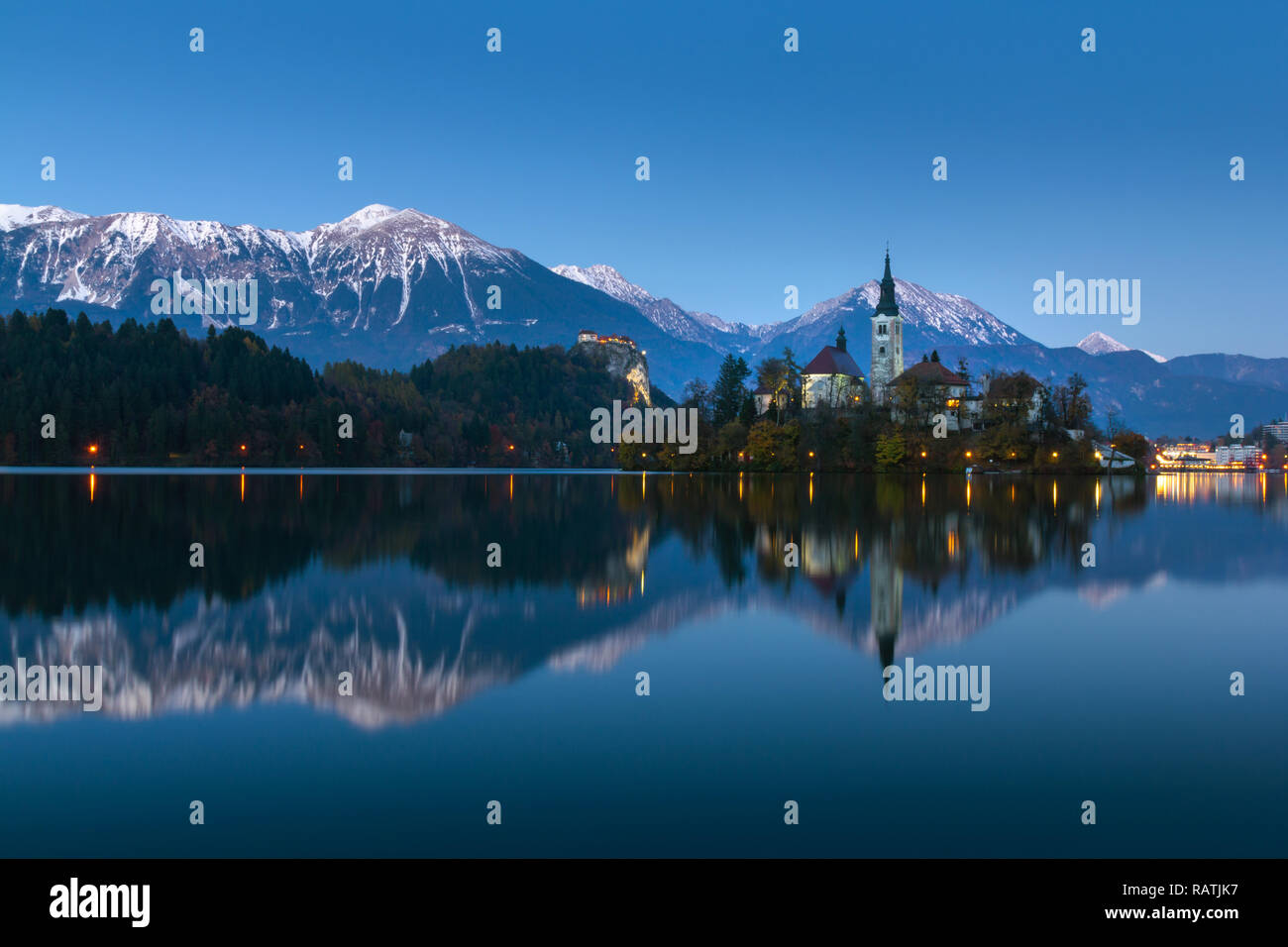 Scenic view of lake Bled at winter night with castle rock and St Martin ...