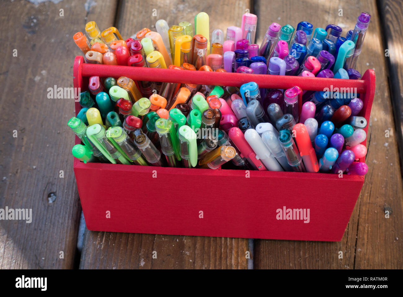 A multitude of artists colored pens in a basket arranged by color, a ...