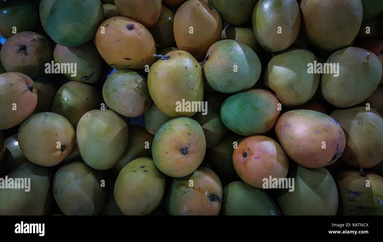 Fresh colorful Asian Mango on the market ready to sale Stock Photo - Alamy