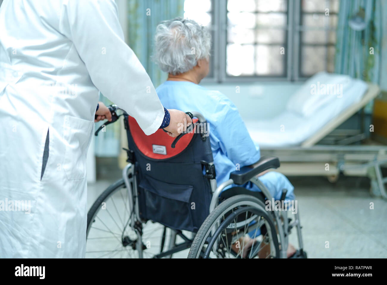 Doctor help and care Asian senior or elderly old lady woman patient sitting on wheelchair at ...