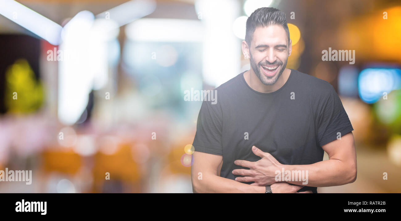 Young handsome man over isolated background Smiling and laughing hard ...
