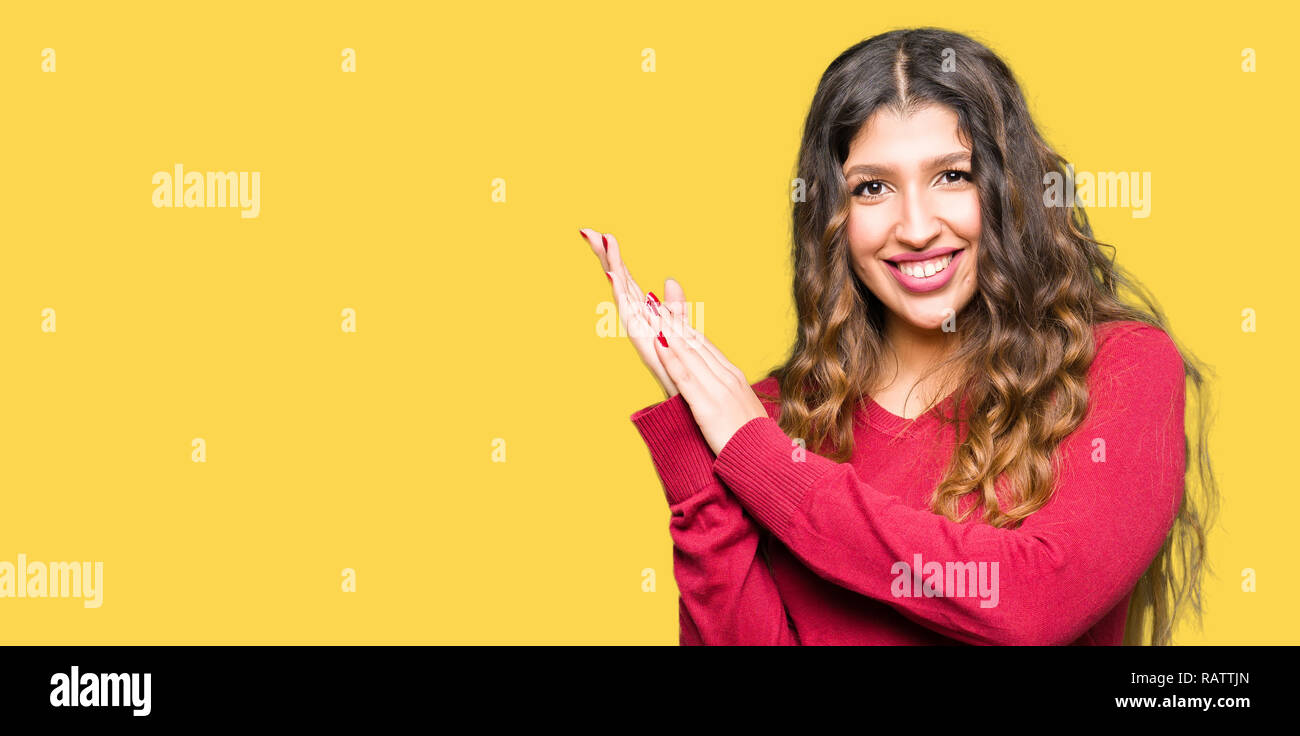 Young beautiful woman wearing red sweater Clapping and applauding happy ...