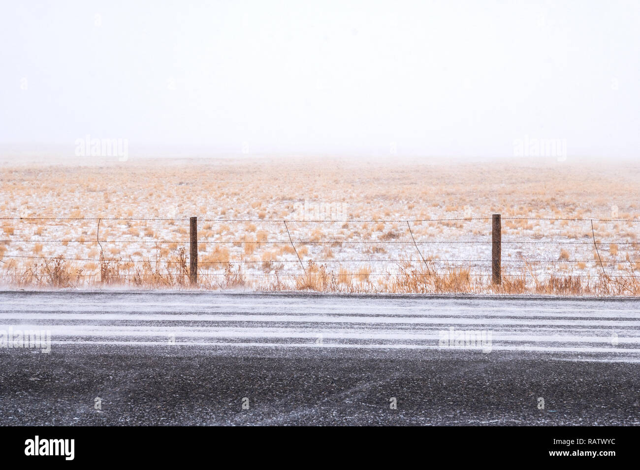 Snow covered Rt. 285; ranch pasture & barbed wire fence near Jefferson ...