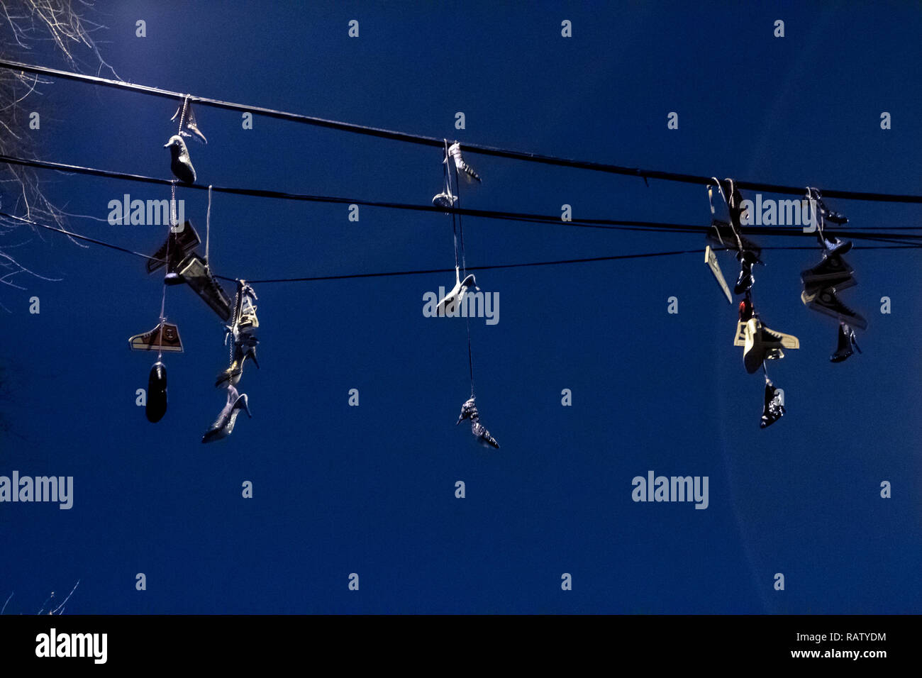 Shoes hanging on power line hi-res stock photography and images - Alamy