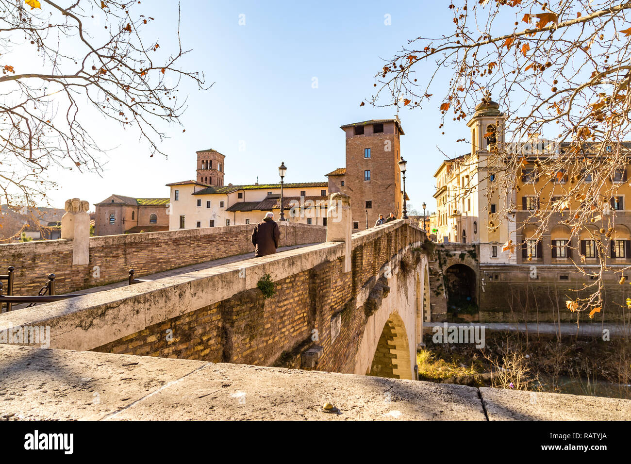 ROME, ITALY - JANUARY 4, 2019: tourists walking on Pons Fabricius, the ...