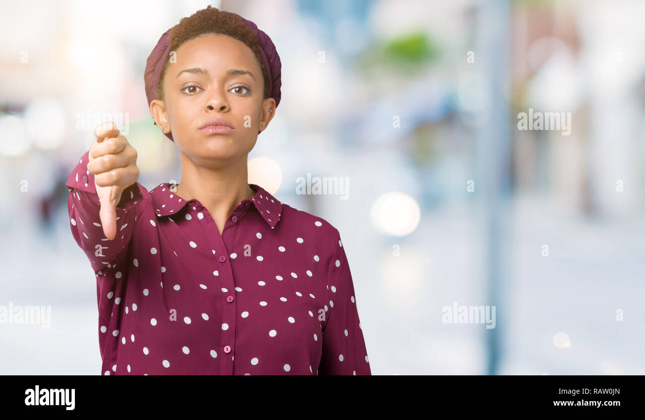 Beautiful young african american woman wearing head scarf over isolated ...