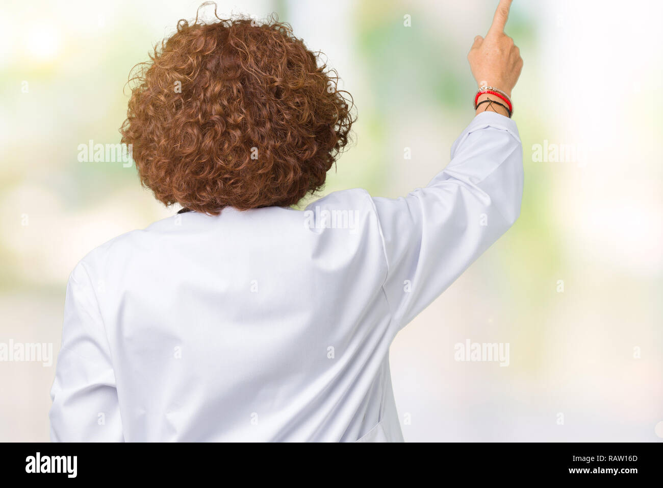 Middle ager senior doctor woman over isolated background Posing ...