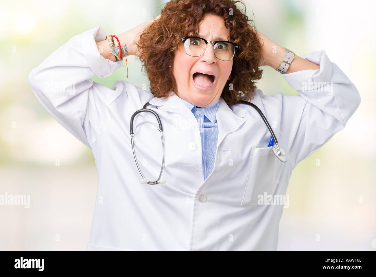 Middle ager senior doctor woman over isolated background Crazy and ...