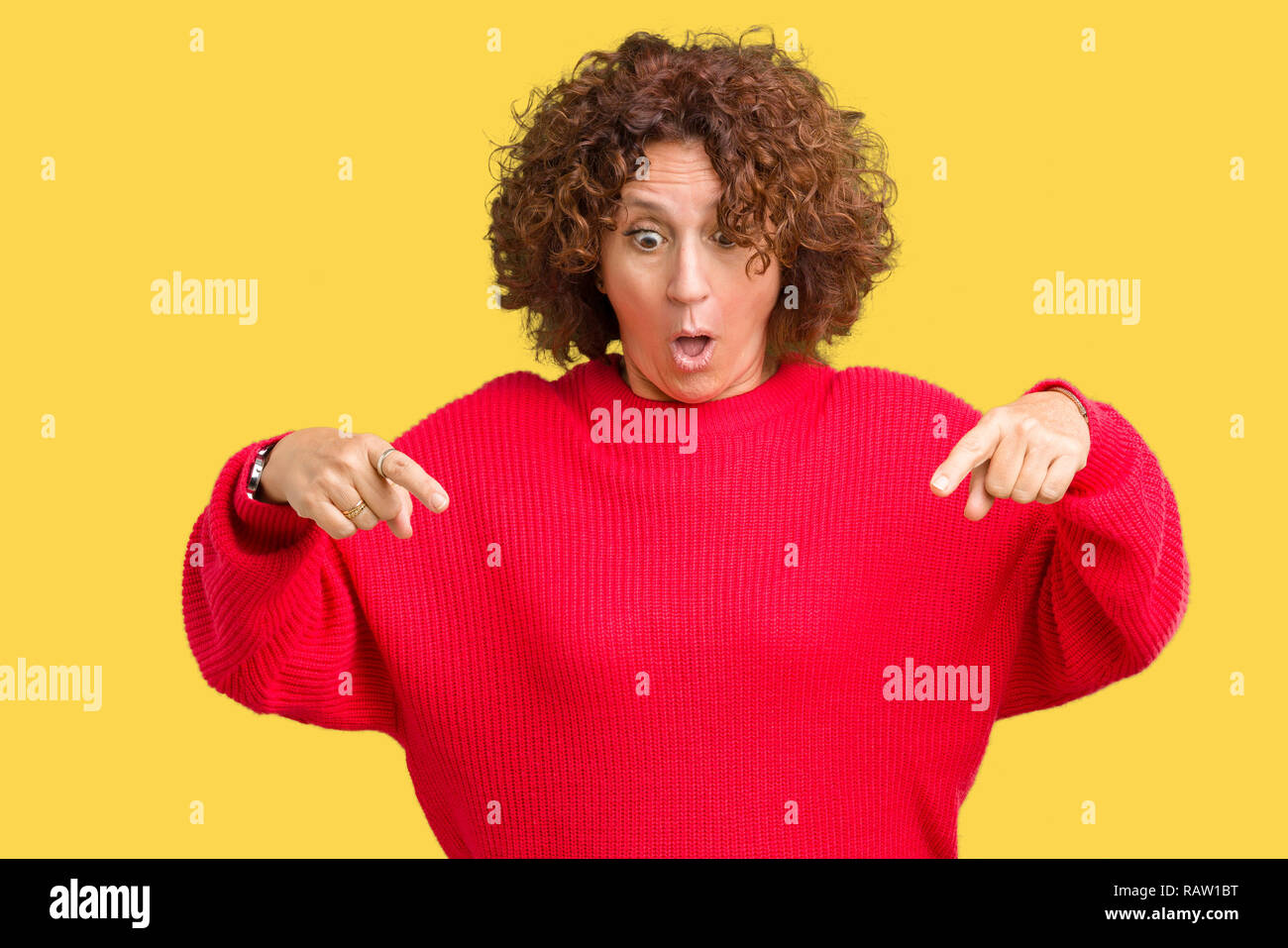 Beautiful middle ager senior woman red winter sweater over isolated ...