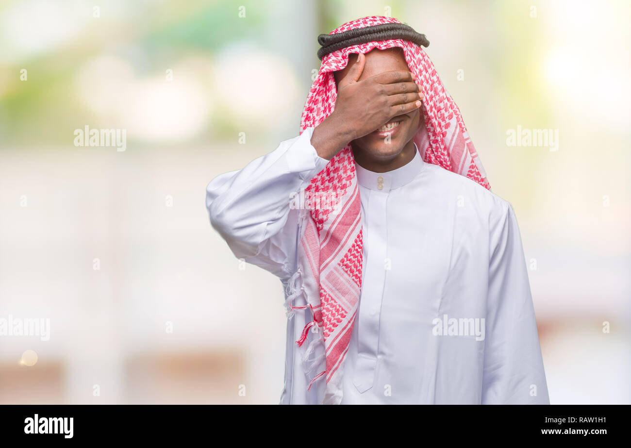 Young arabic african man wearing traditional keffiyeh over isolated ...