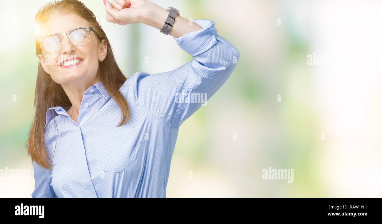 Beautiful middle age mature business woman wearing glasses over ...