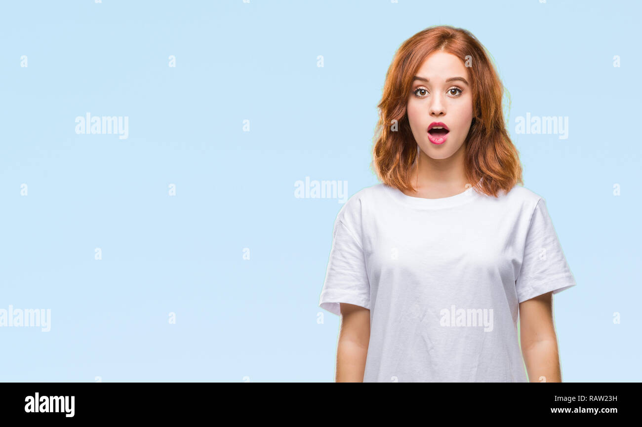 Young beautiful woman over isolated background afraid and shocked with ...