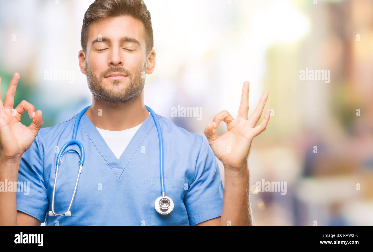 Young handsome doctor surgeon man over isolated background relax and ...
