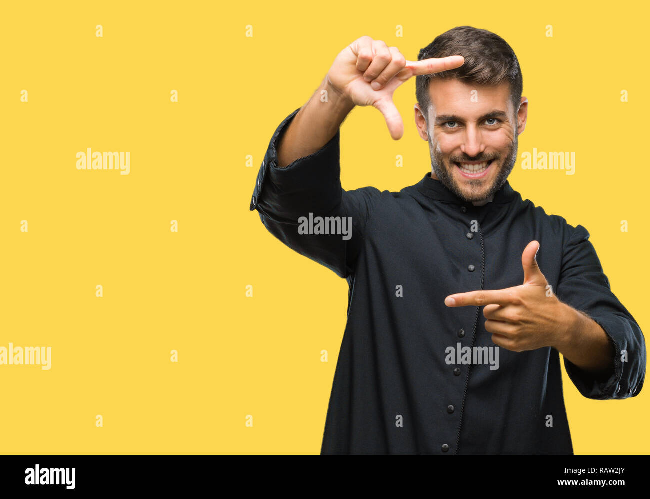 Young catholic christian priest man over isolated background smiling ...