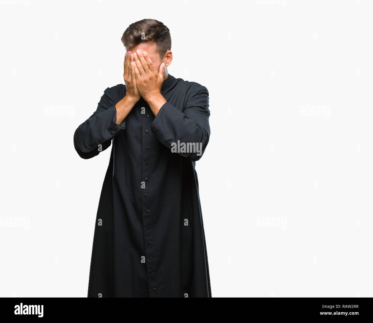 Young catholic christian priest man over isolated background with sad ...