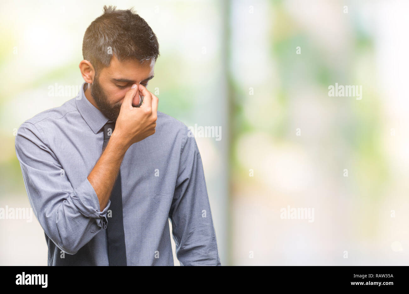Adult hispanic business man over isolated background tired rubbing nose ...