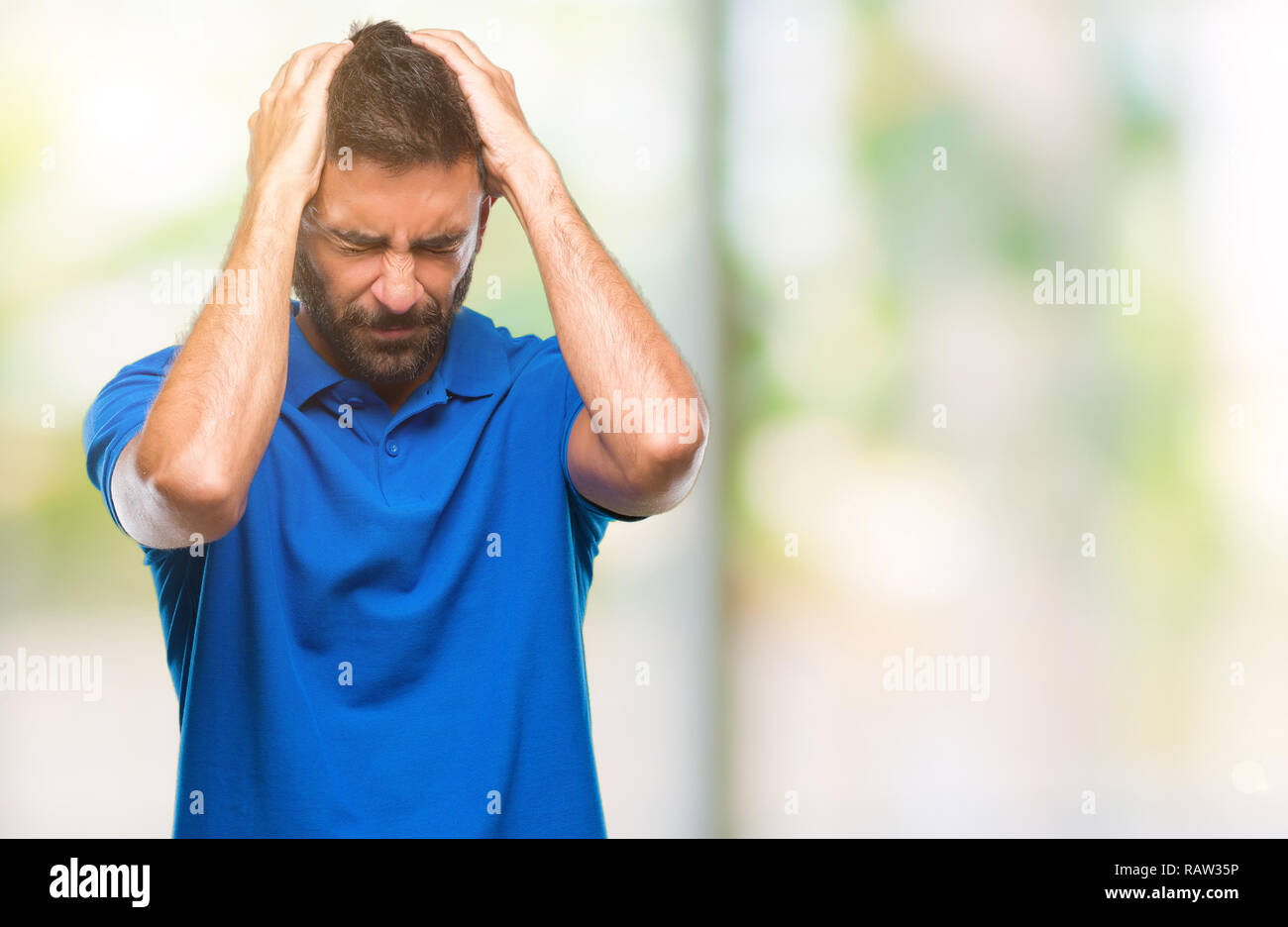 Adult hispanic man over isolated background suffering from headache ...