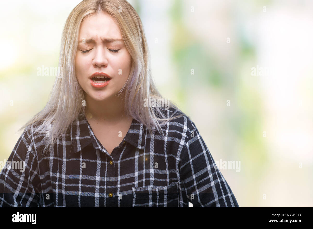 Young blonde woman over isolated background with hand on stomach ...