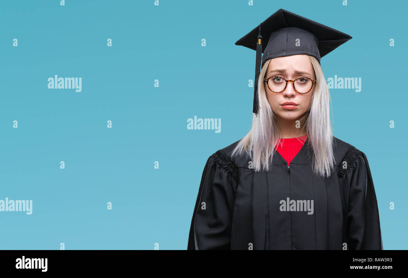 Young blonde woman wearing graduate uniform over isolated background ...