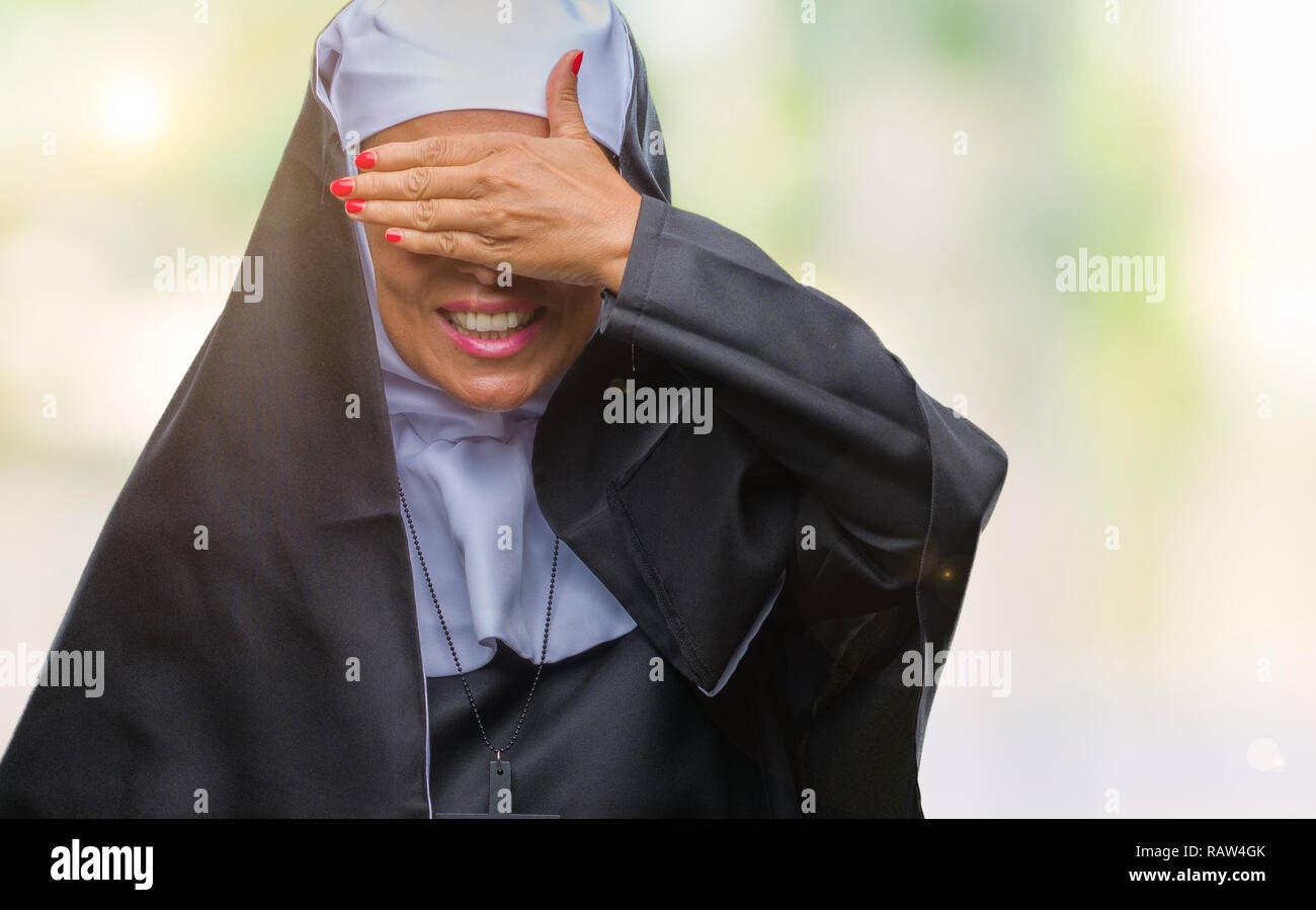 Middle age senior christian catholic nun woman over isolated background ...