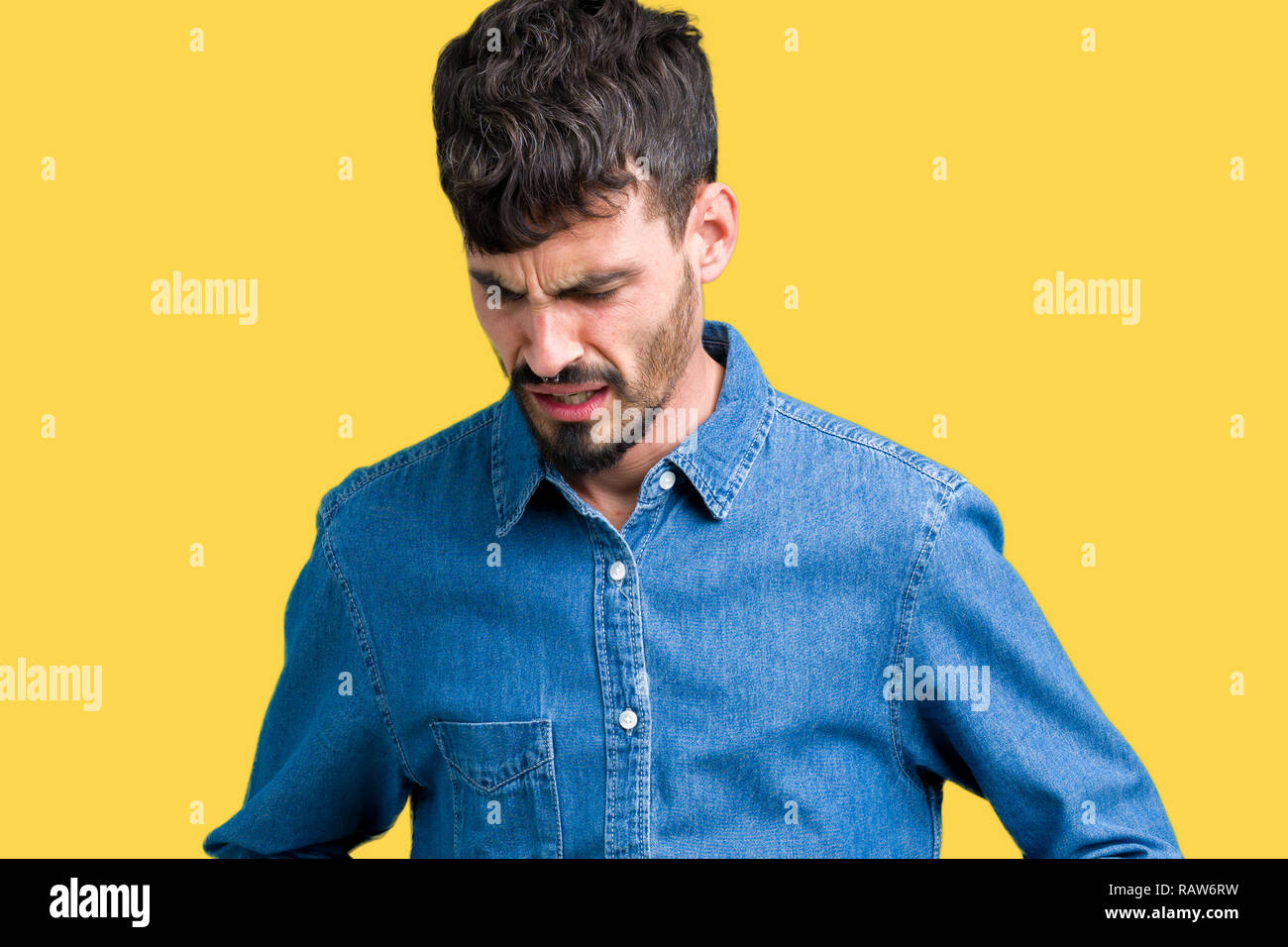 Young handsome man over isolated background with hand on stomach ...
