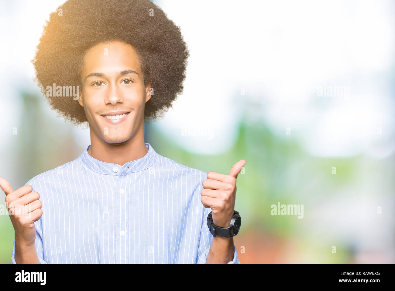 Young african american man with afro hair success sign doing positive ...
