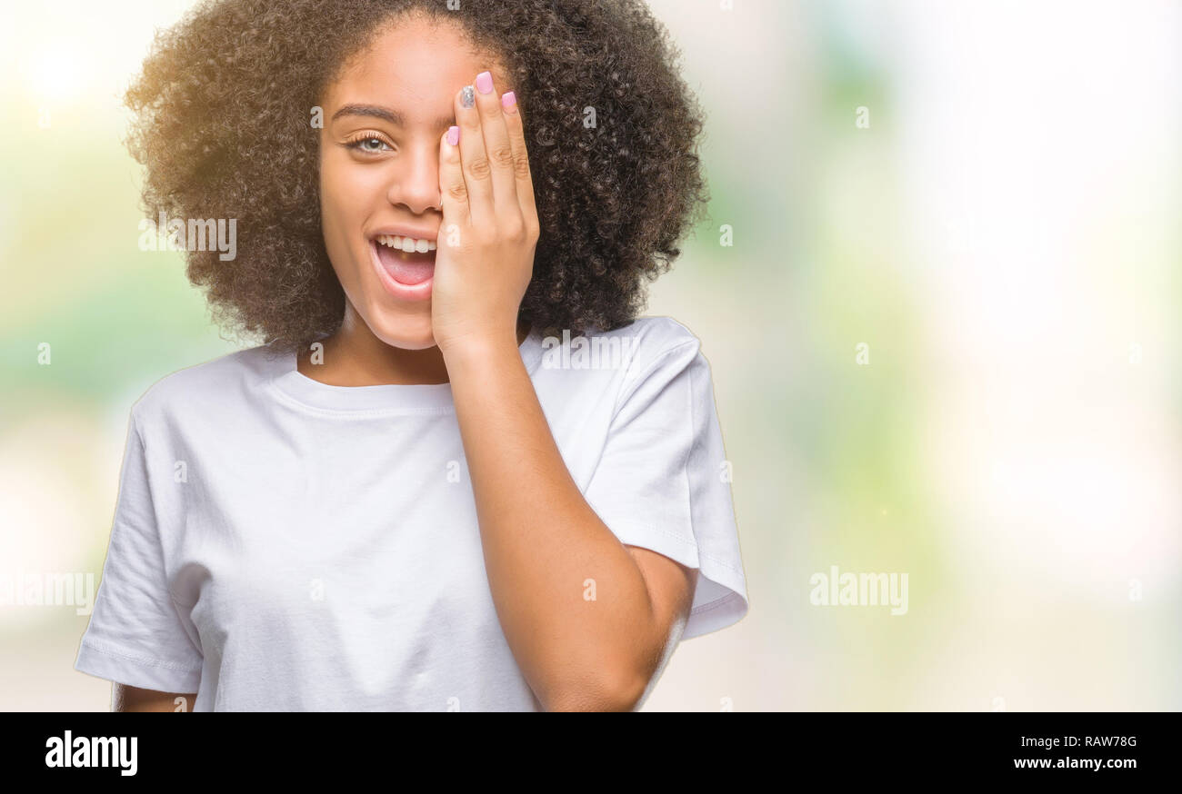 Young afro american woman over isolated background covering one eye ...