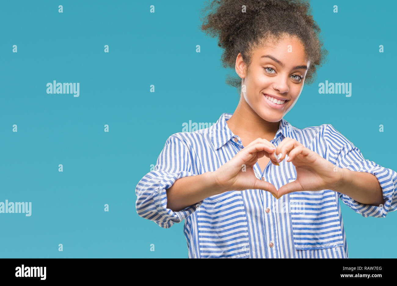 Young afro american woman over isolated background smiling in love ...