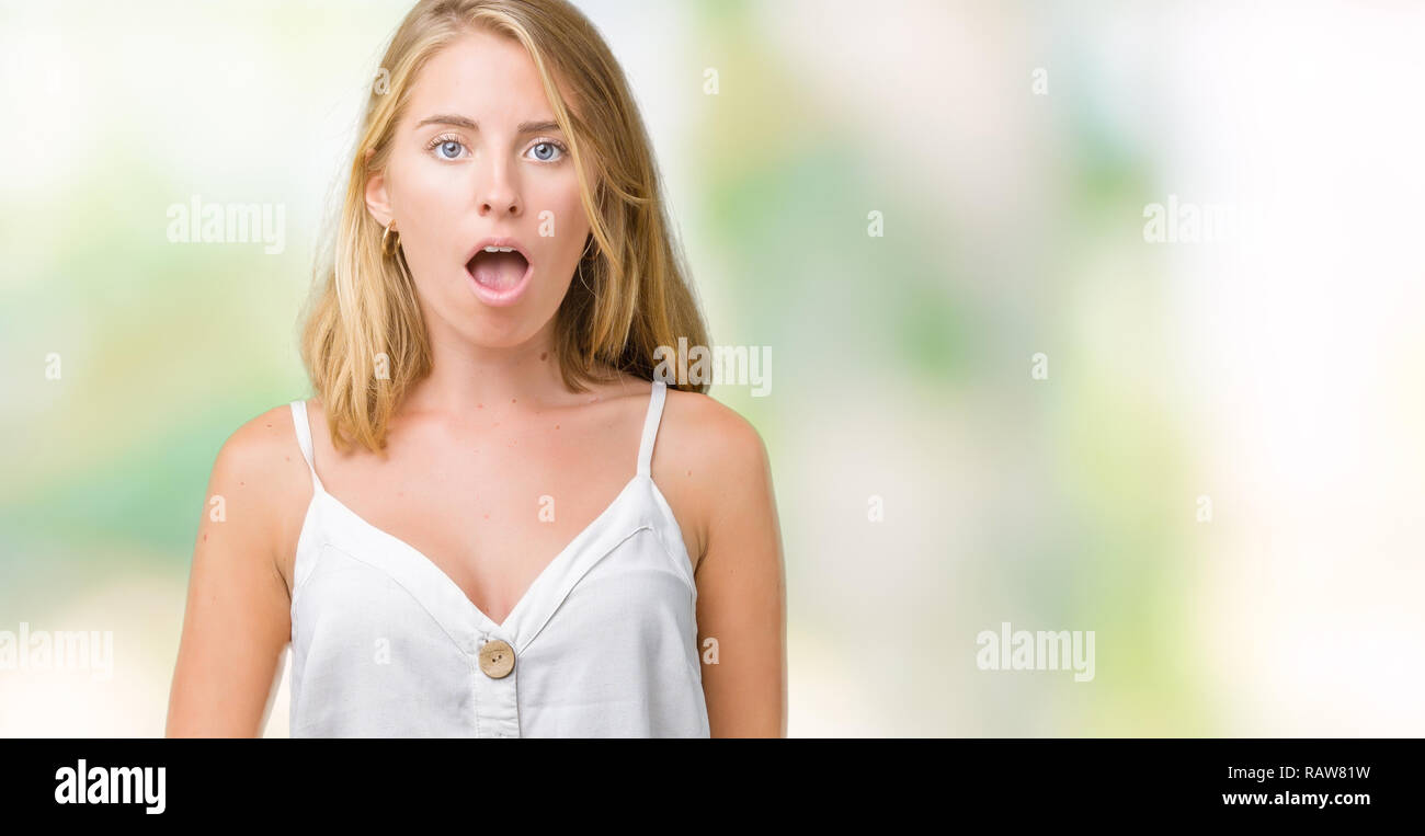 Beautiful young woman over isolated background In shock face, looking ...