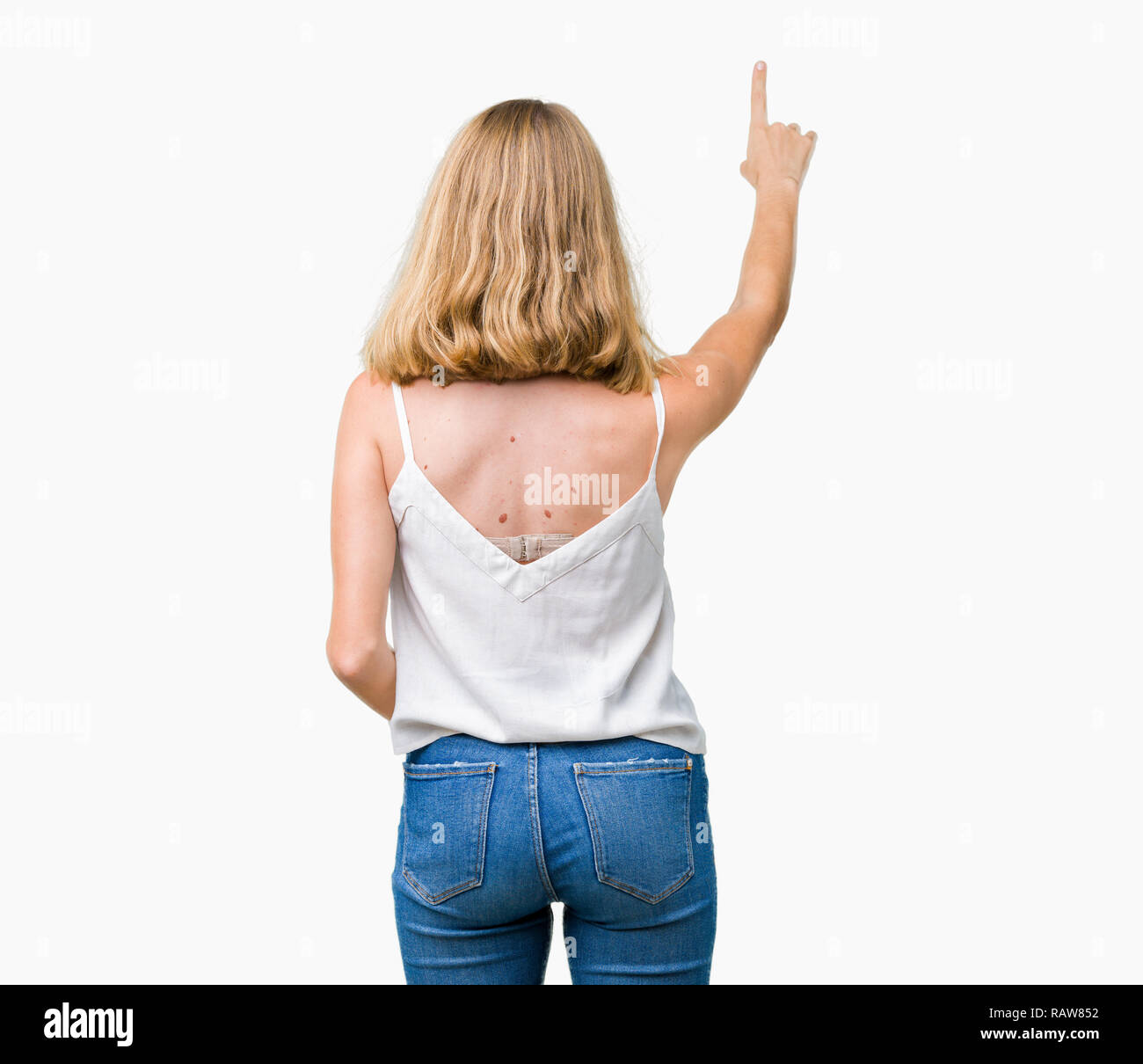 Beautiful young woman over isolated background Posing backwards ...