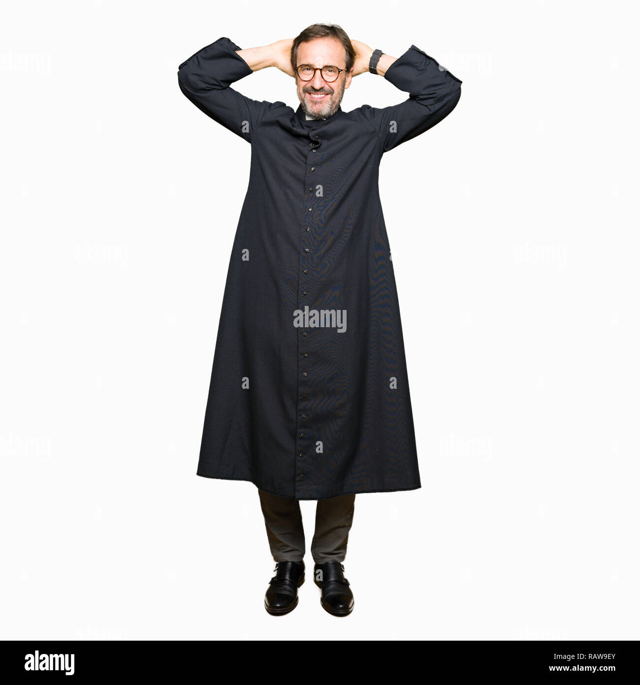 Middle age priest man wearing catholic robe Relaxing and stretching ...