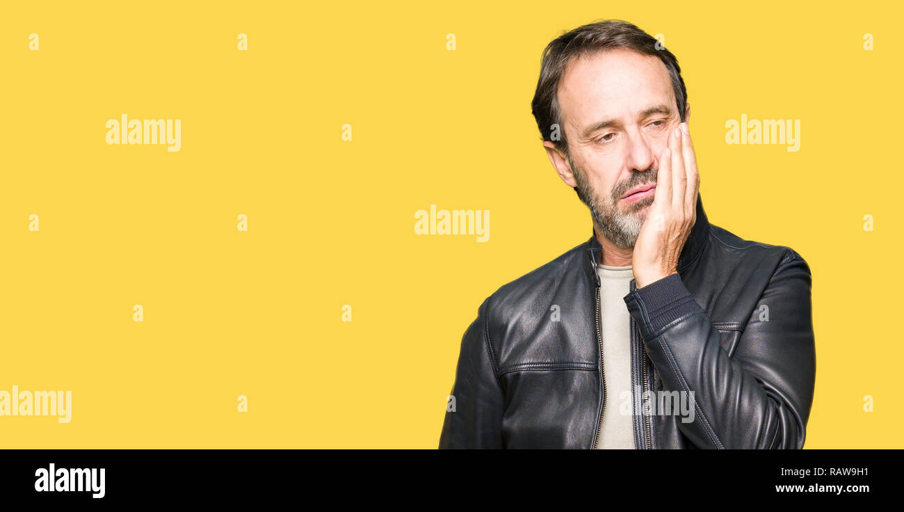 Middle age handsome man wearing black leather jacket thinking looking ...