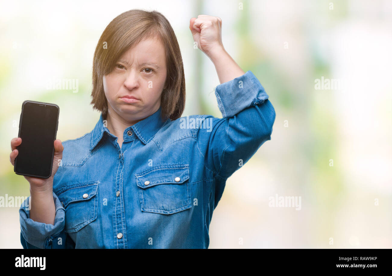 Young adult woman with down syndrome showing smartphone screen over ...