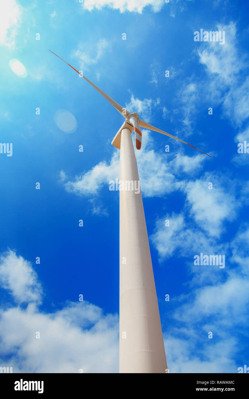 windmill in sunny day on sky blue background, production of wind energy ...