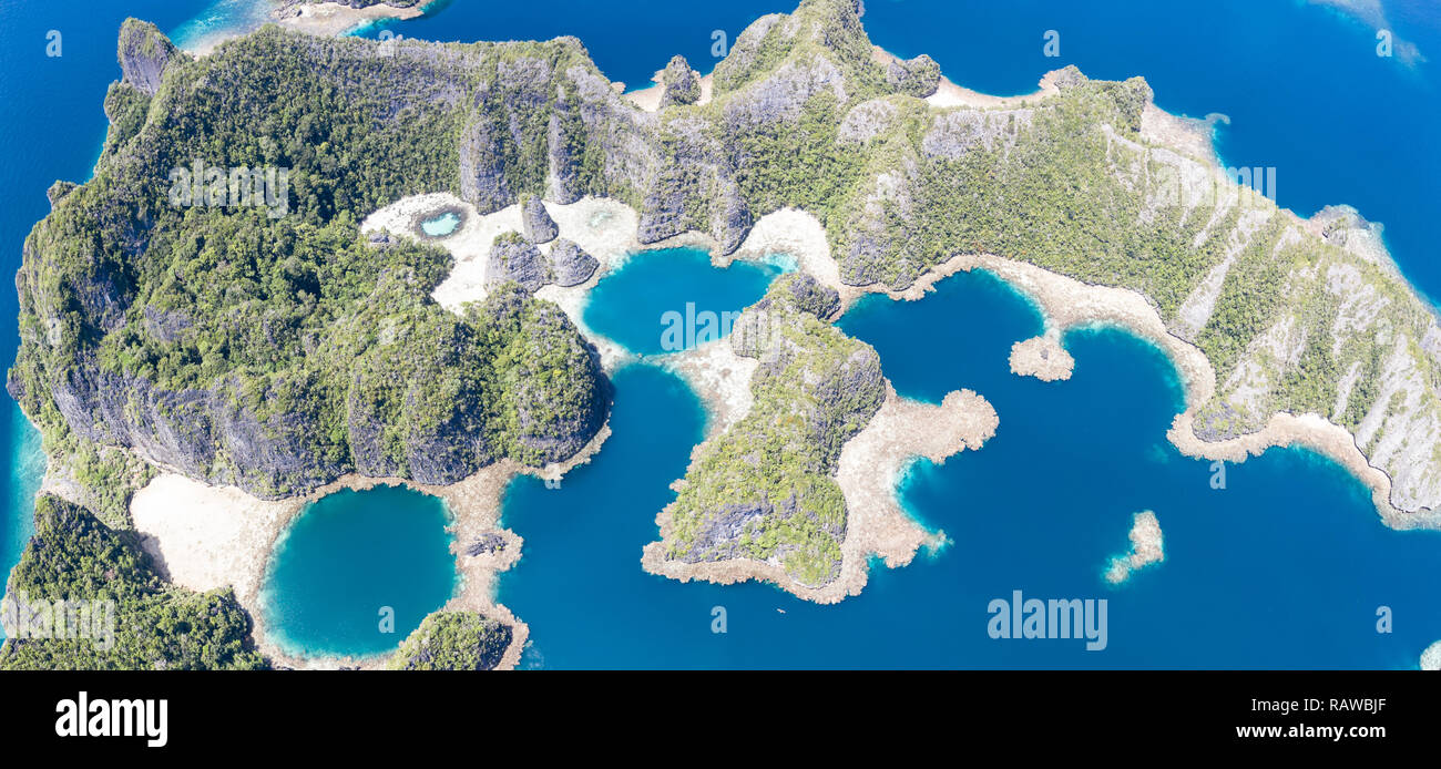 Remote limestone islands rise from the stunning seascape in Raja Ampat ...