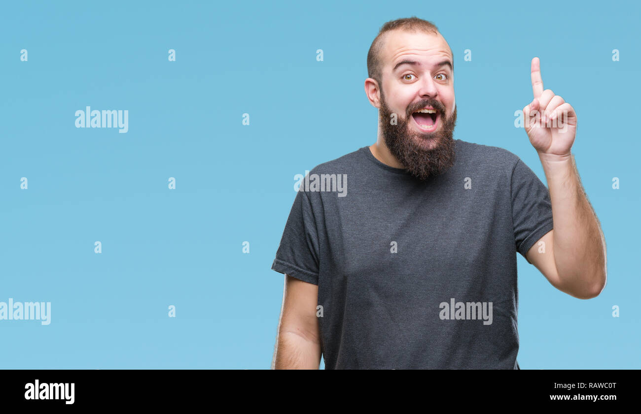 Young caucasian hipster man over isolated background pointing finger up ...